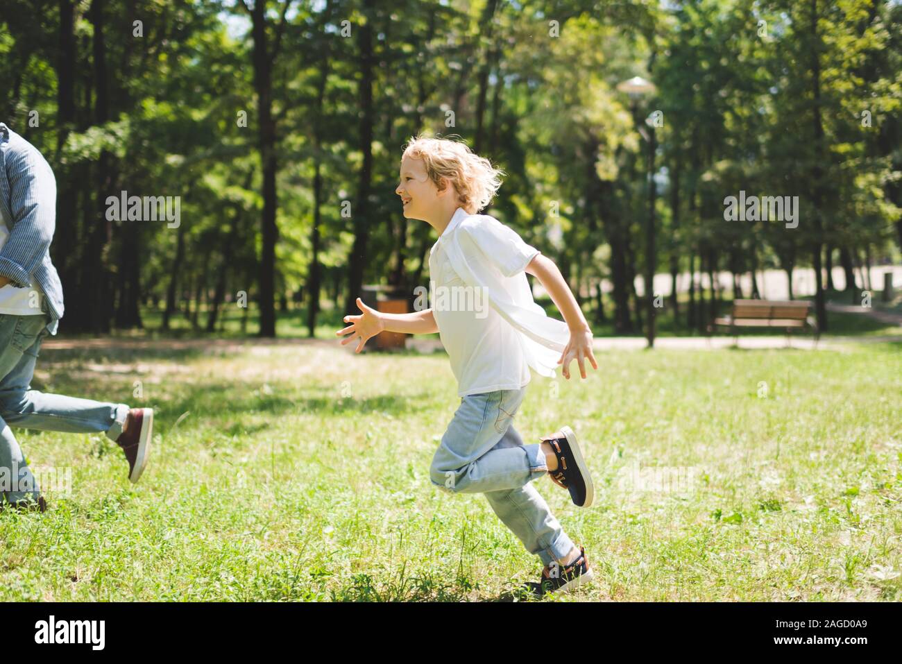 happy son running with father in park during daytime Stock Photo - Alamy