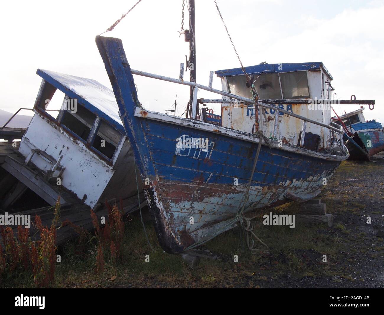 Scrapped old artisanal fishing vessels in a ship graveyard near Puerto ...