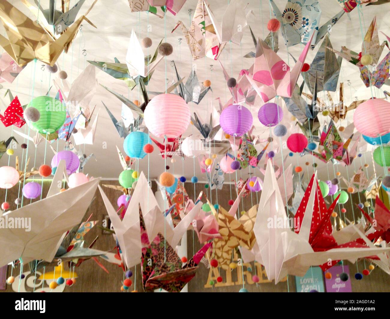 Colorful image of paper lamps and origami seagulls hanging from a white ...