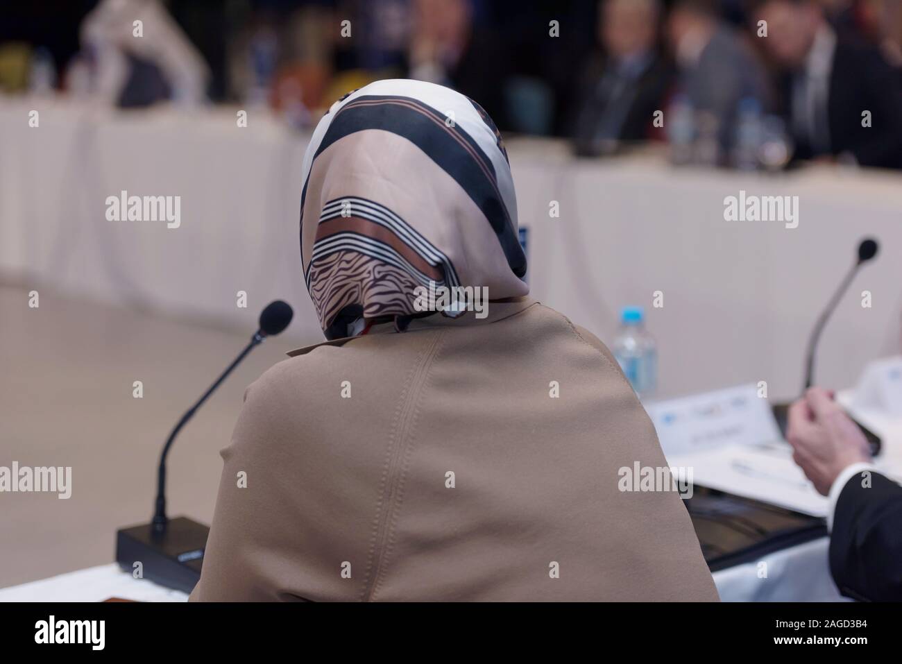 Business muslim woman as leader speaking at Conference. Audience at the ...