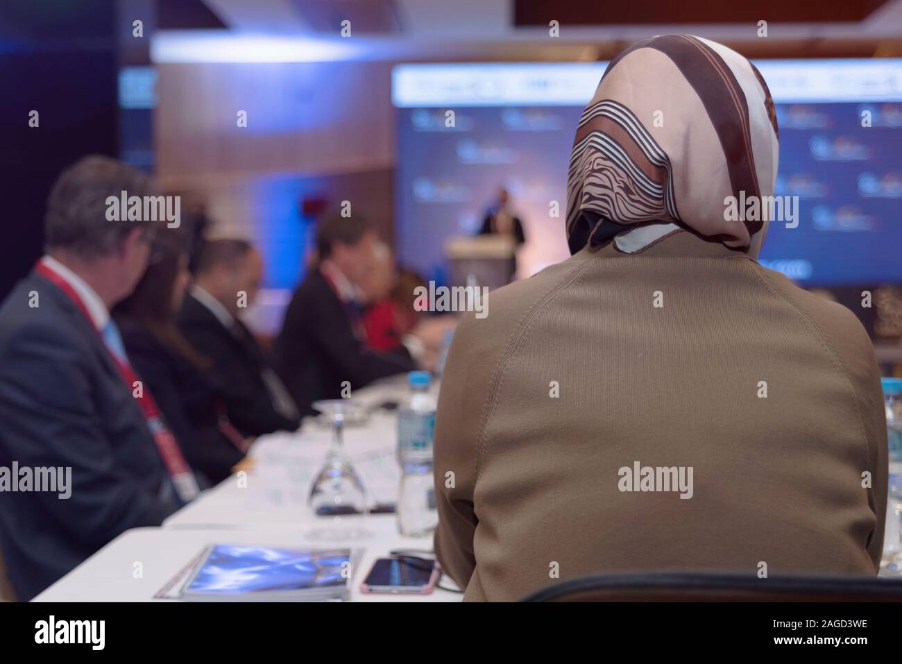 Business muslim woman as leader speaking at Conference. Audience at the ...