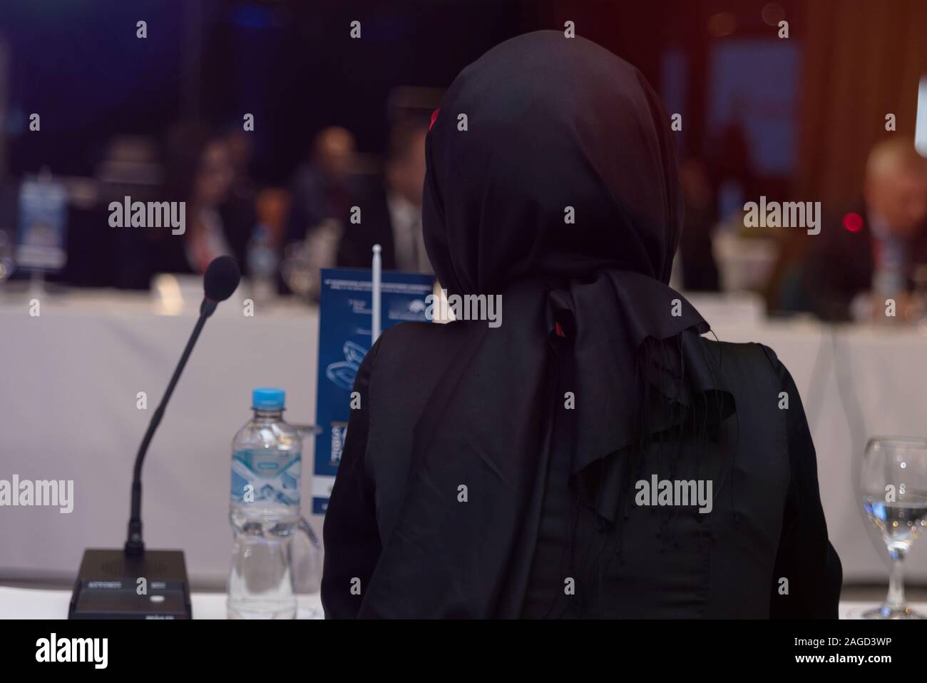 Business muslim woman as leader speaking at Conference. Audience at the ...