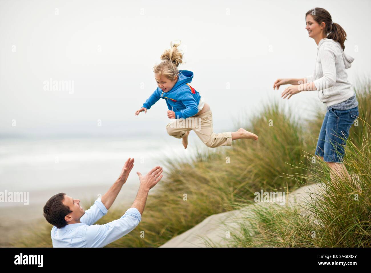 Child jumping fathers arms hi-res stock photography and images - Alamy
