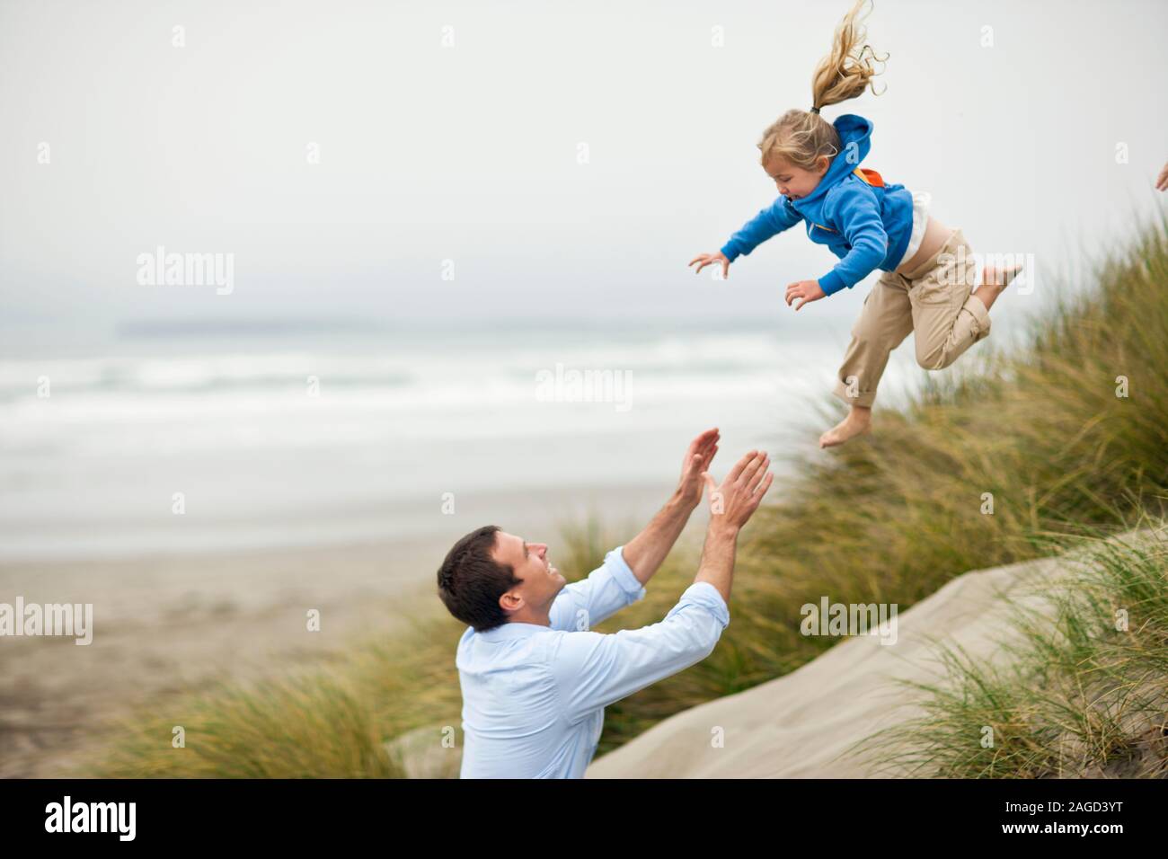 Child jumping fathers arms hi-res stock photography and images - Alamy