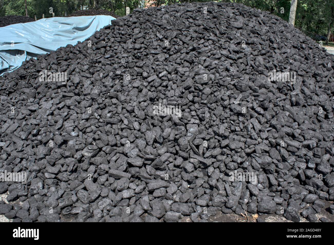 A pile of brown coal in a warehouse waiting for customers for the ...