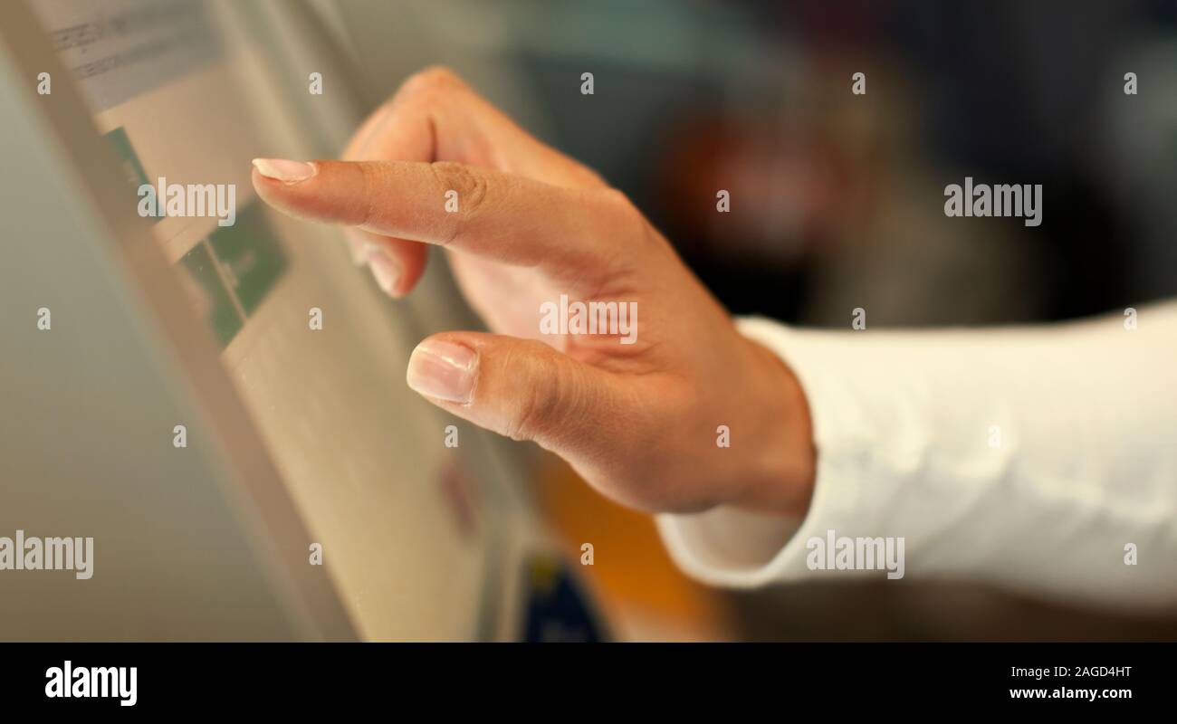 Hand of a mid adult man using a touch screen Stock Photo - Alamy