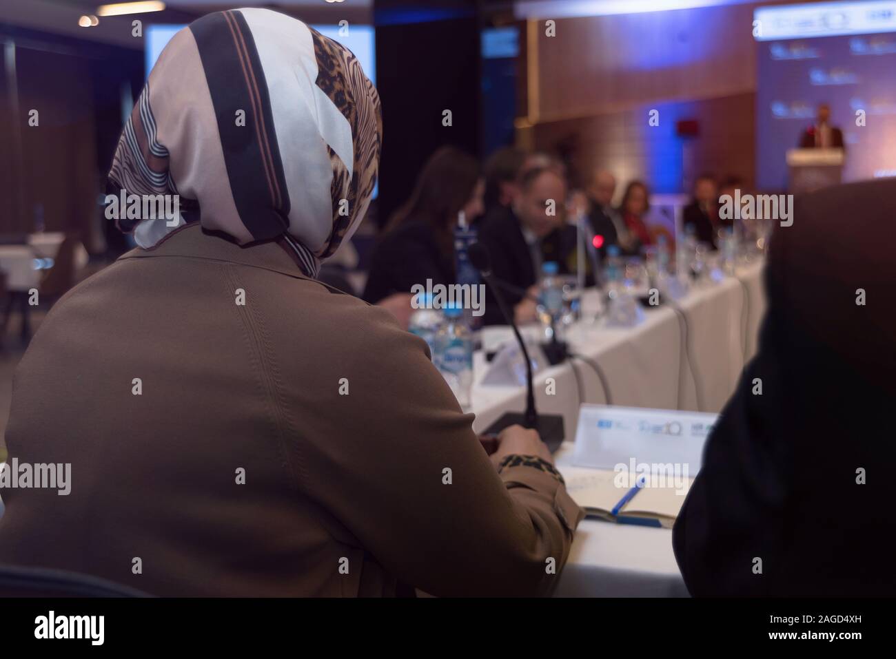Business muslim woman as leader speaking at Conference. Audience at the ...
