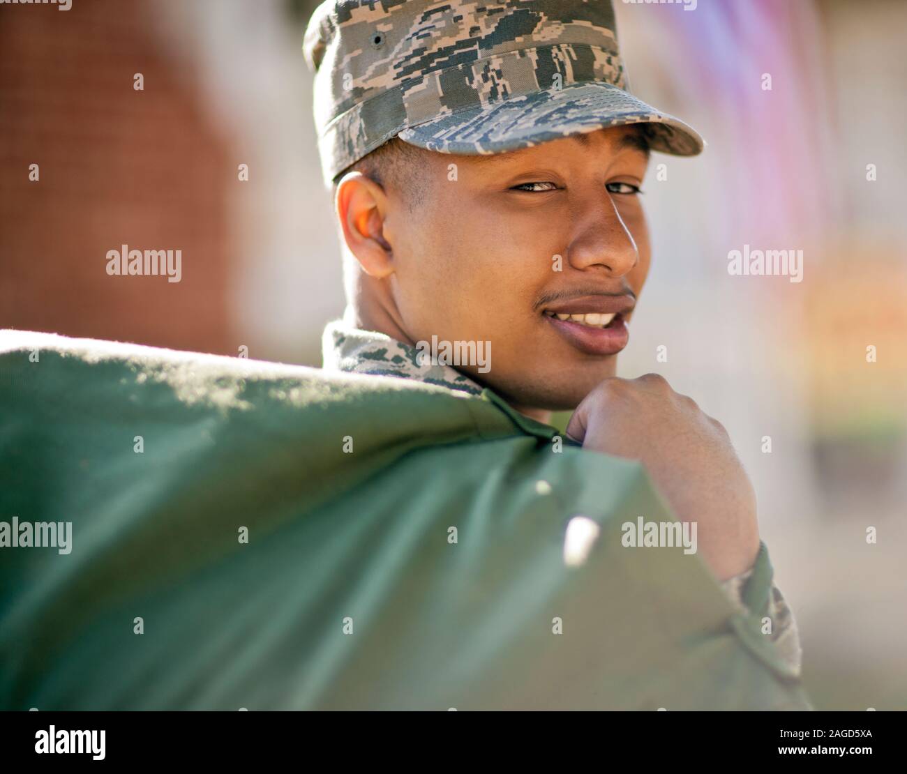 Portrait of a smiling soldier carrying a bag over his shoulder Stock ...