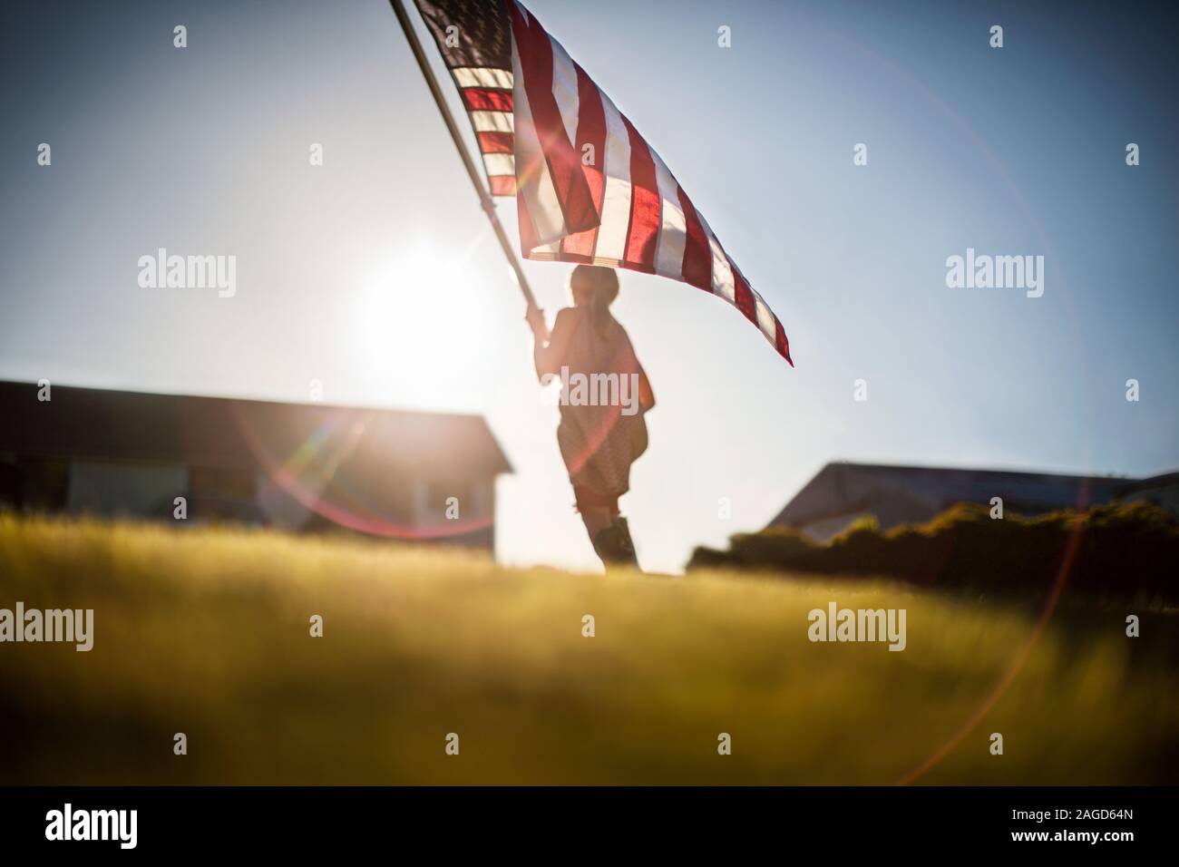 Young girl running while carrying an American flag Stock Photo - Alamy