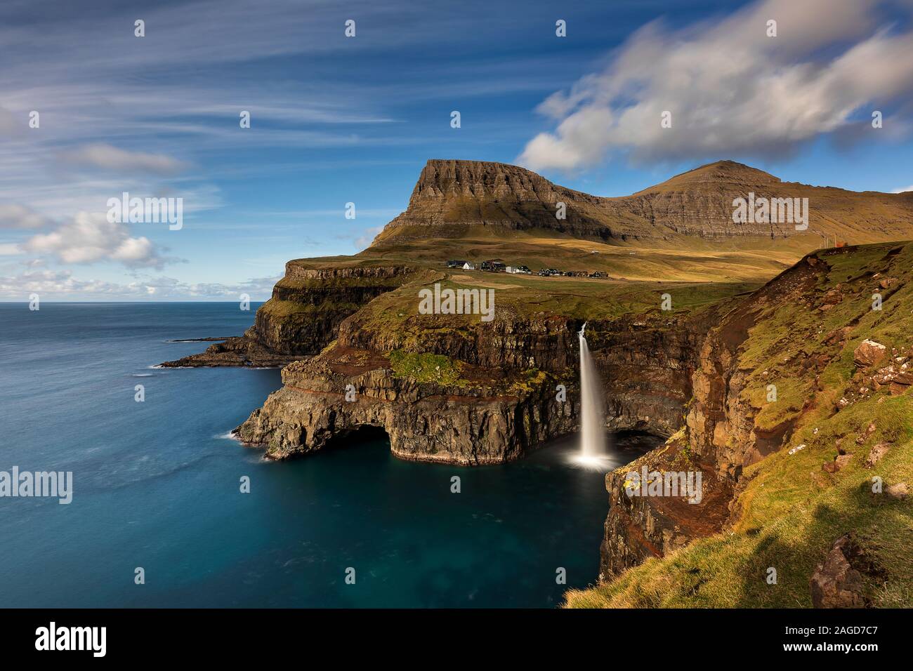 Gasadalur village and amazing waterfall Mulafossur with rainbow above ...