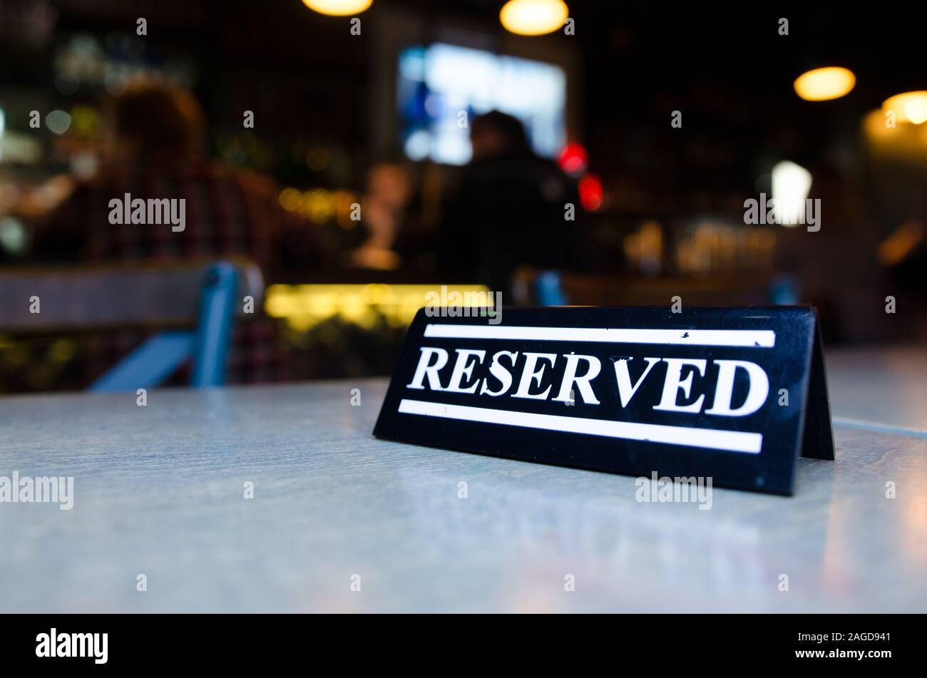 Black plastic signboard place on the wooden dining table. Restaurant ...