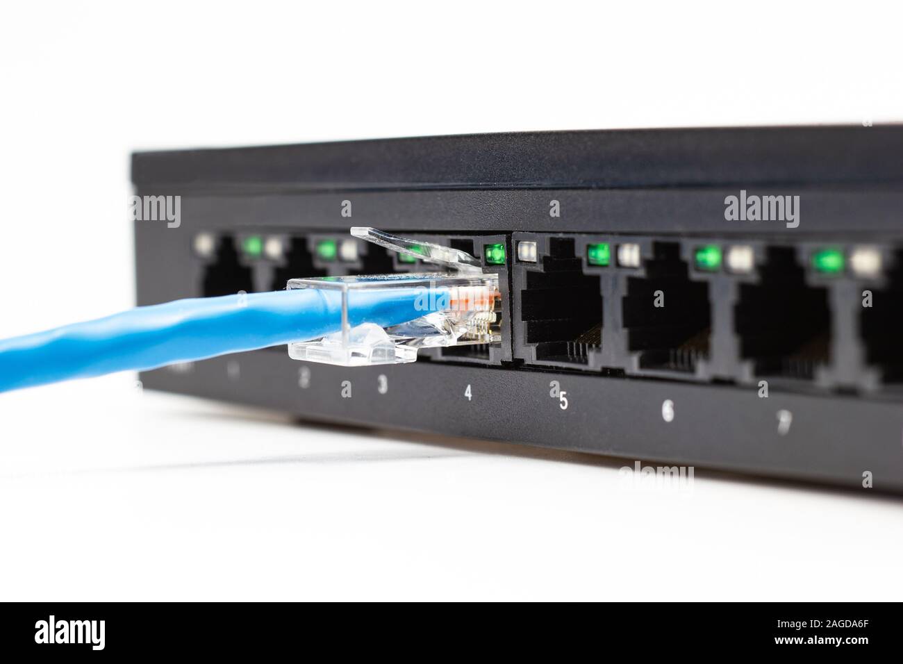The blue network cables connect port switch on white table concept ...