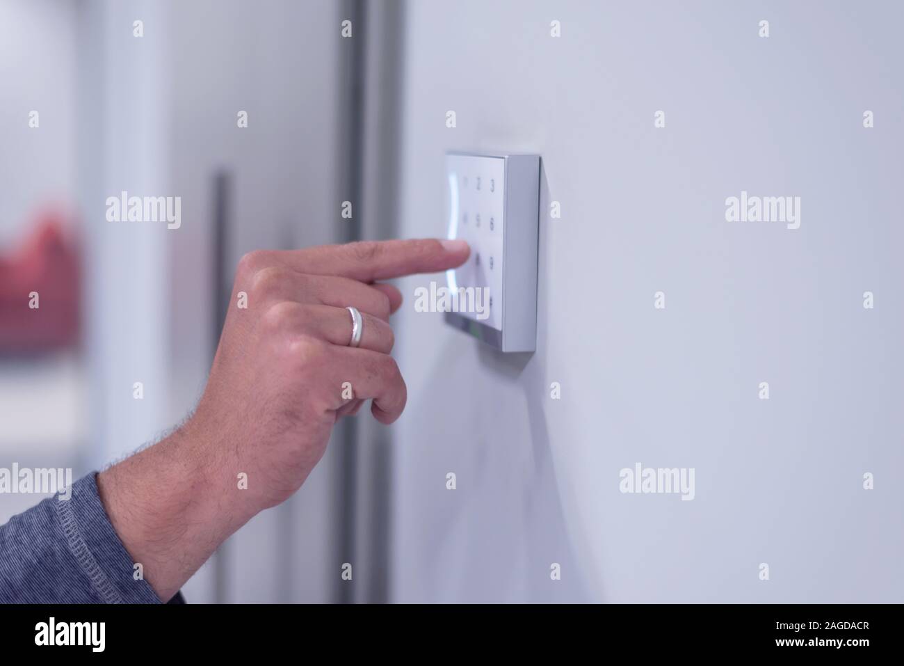 Young businessman entering access code at building entrance. The smart ...