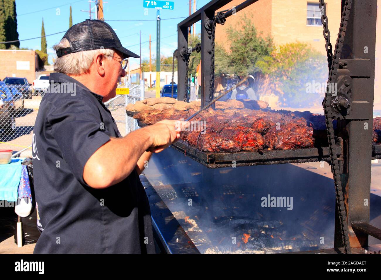 Slabs of tri-tip beef being turned by the chef and cooked by a food ...