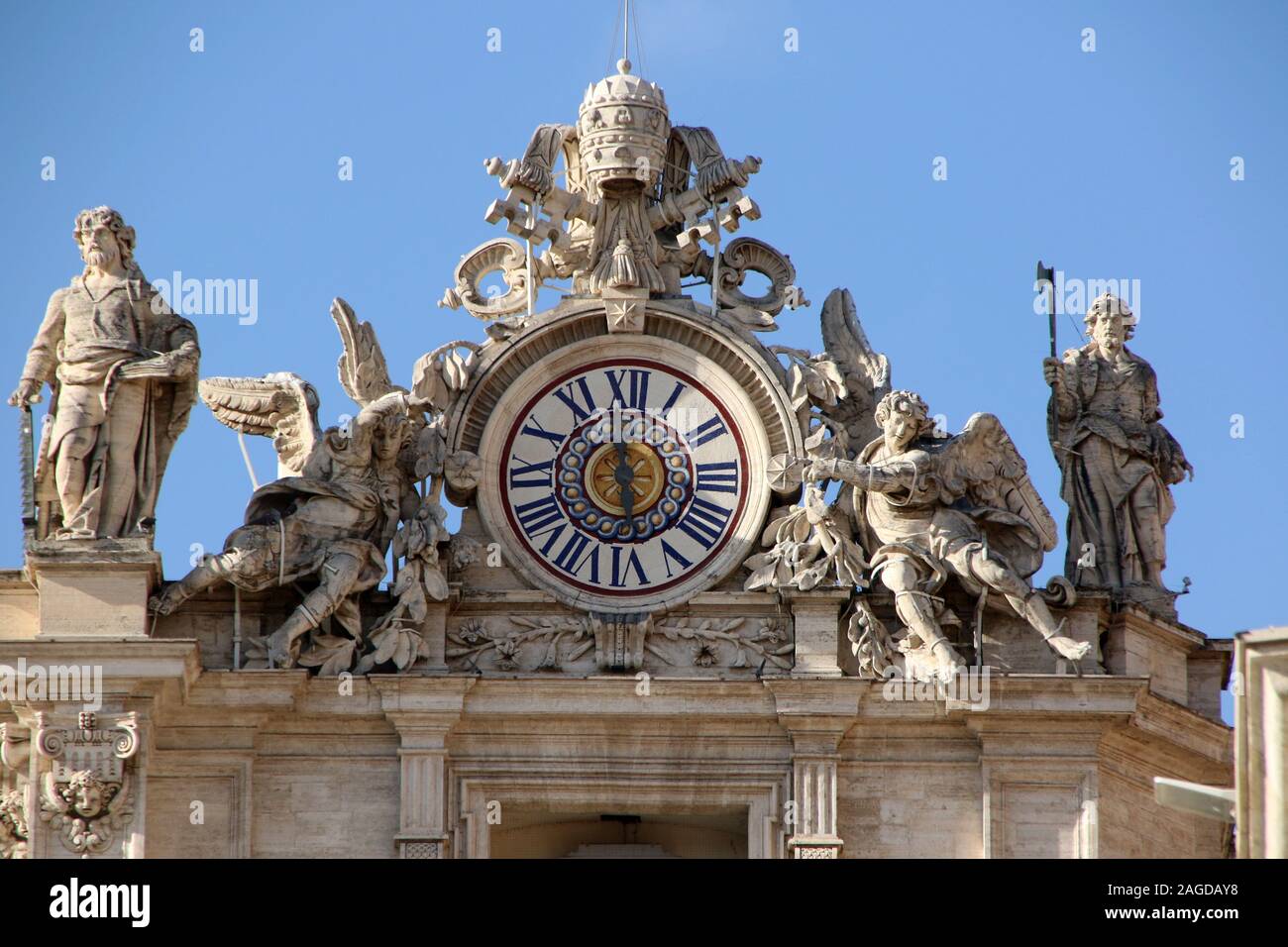 Beautiful sculptures and the clock at the roof of St. Peter's Basilica ...
