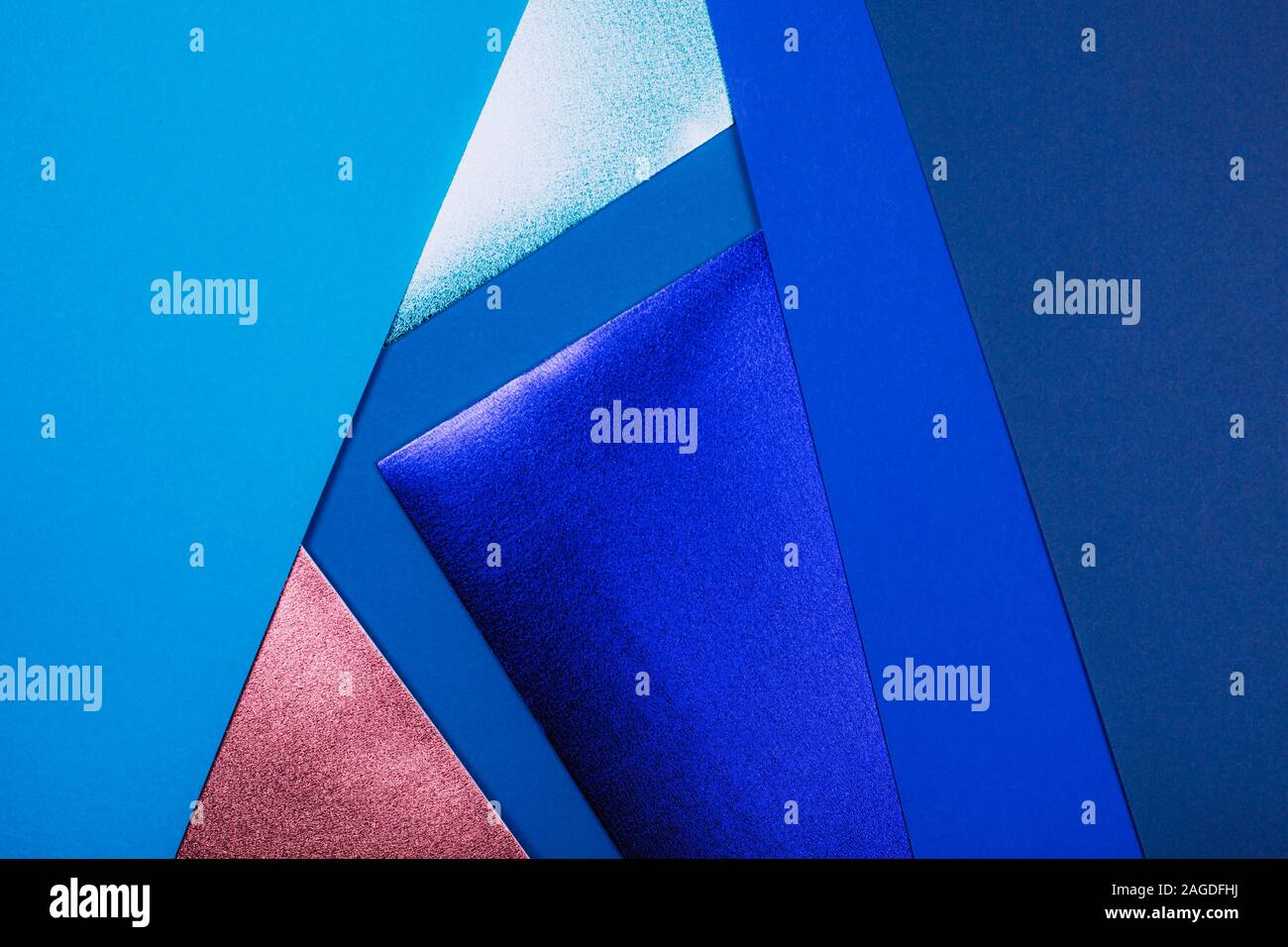 Divided in several parts blue paper background with metallic elemments ...
