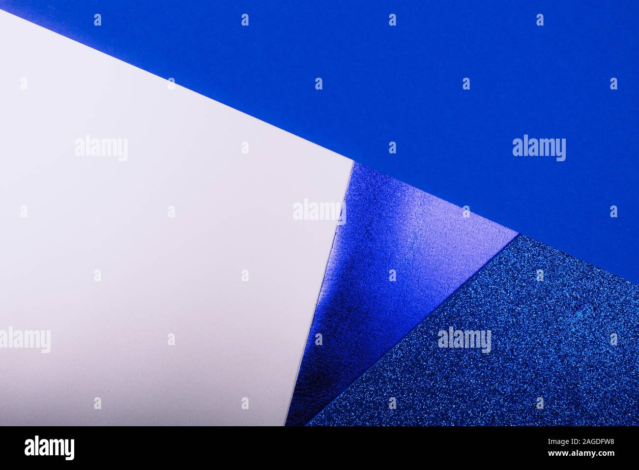 Divided in several parts blue paper background with metallic elemments ...