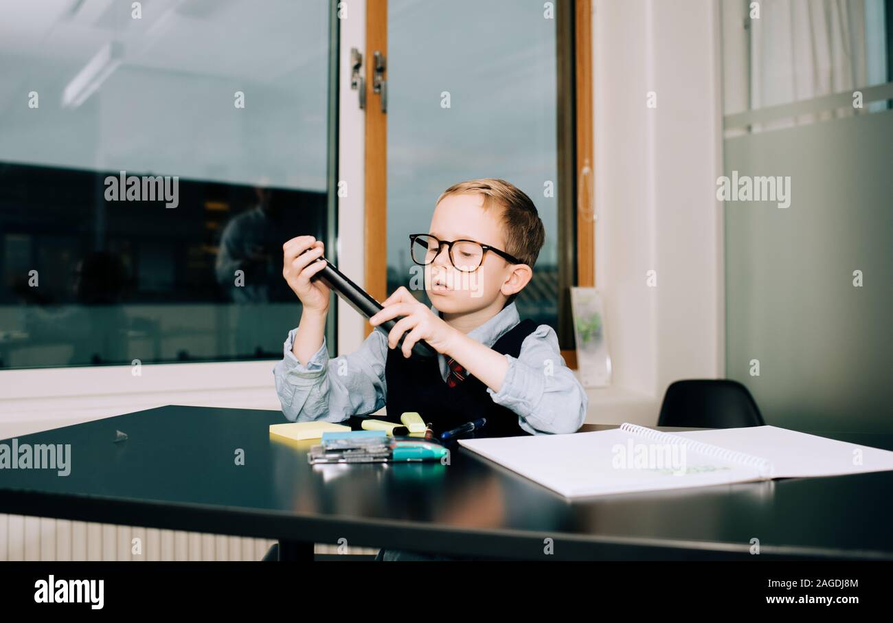 young boy working in an office with his dad doing a presentation Stock ...