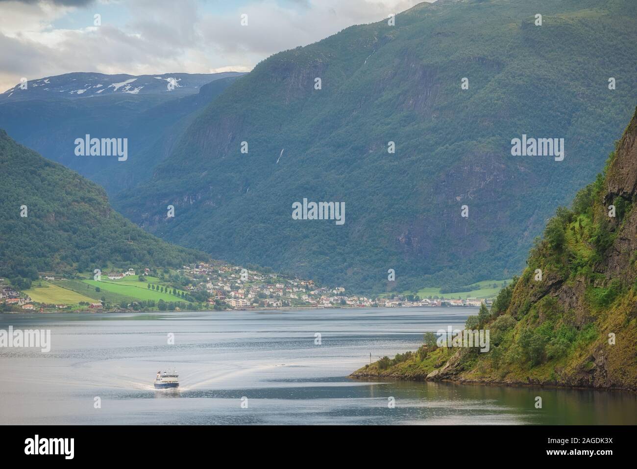 Small boat sailing surrounded by the Norway fjords Stock Photo - Alamy