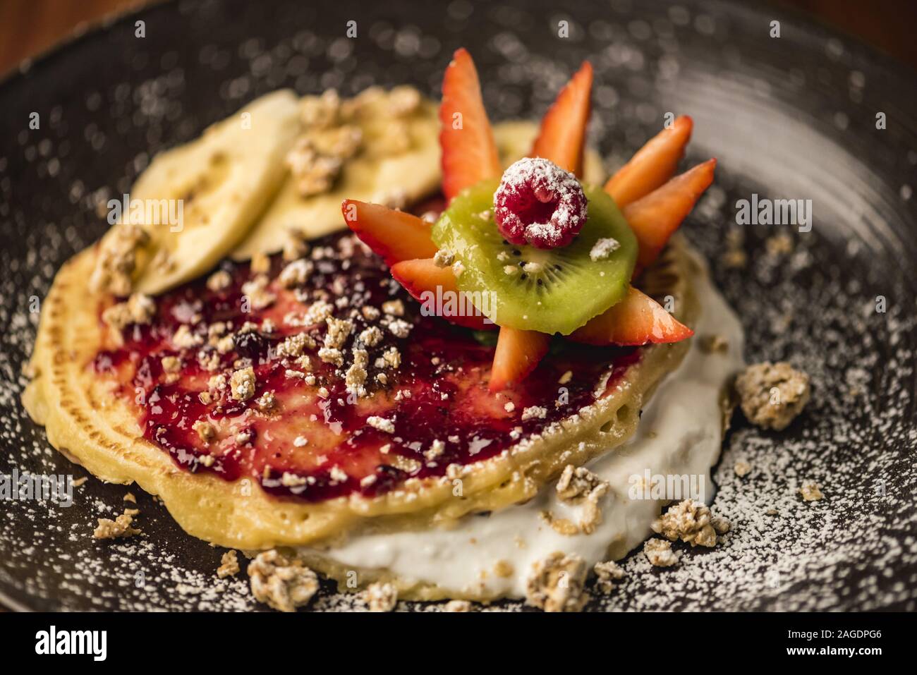 Delicious tasty breakfast made with pancakes and exotic fruits Stock ...