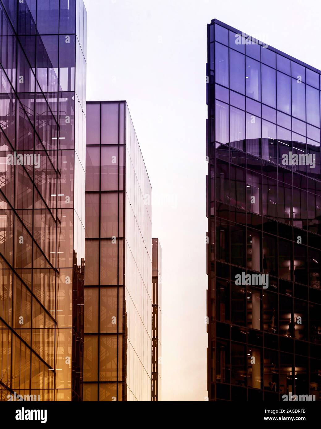 Vertical shot of high rise buildings in a glass facade with reflective ...