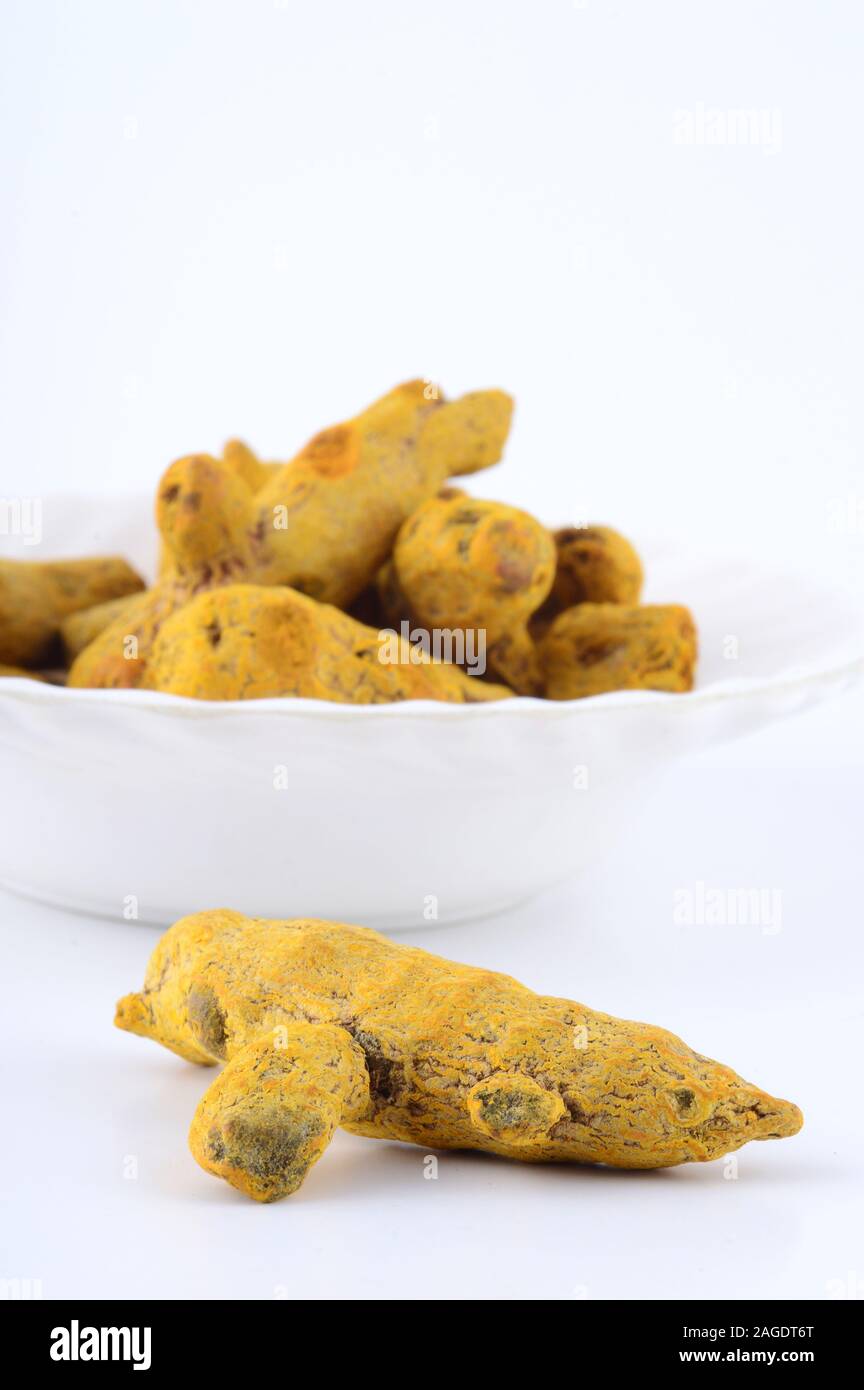 Dry Turmeric roots or barks in white plate isolated on white background ...