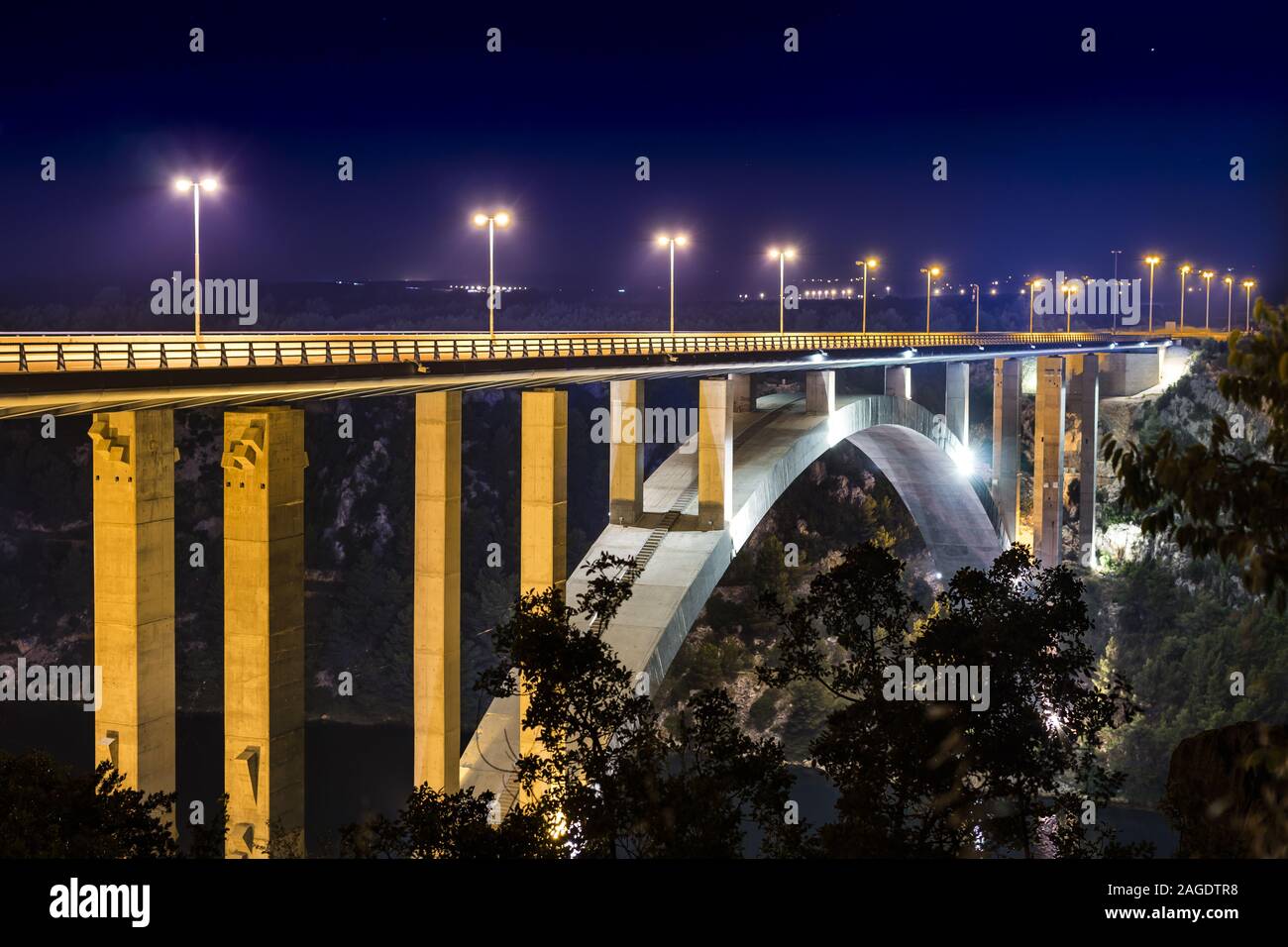 Suspension bridge with concrete columns under the night sky Stock Photo ...