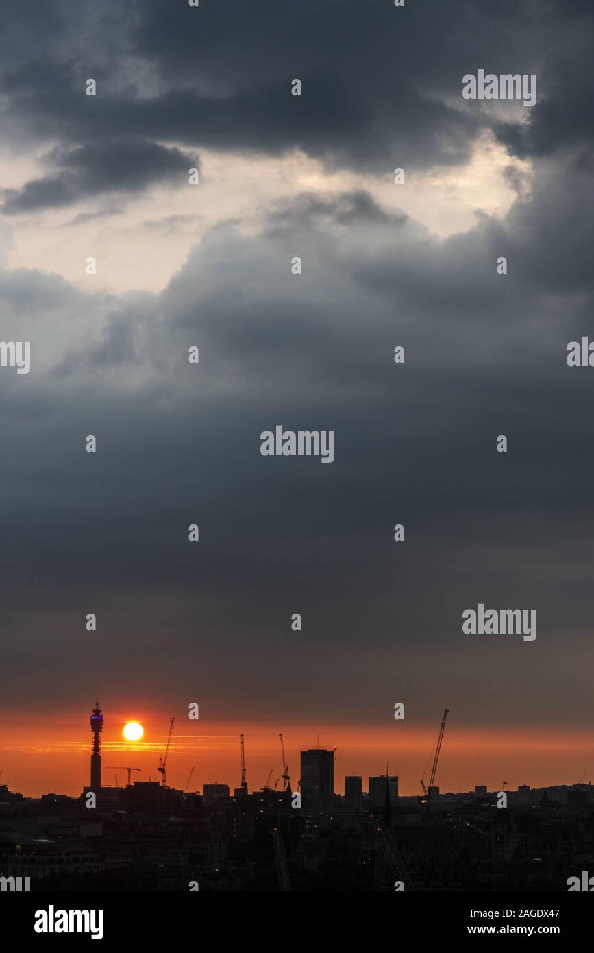 Vertical picture of a city silhouette during a beautiful sunset under a ...