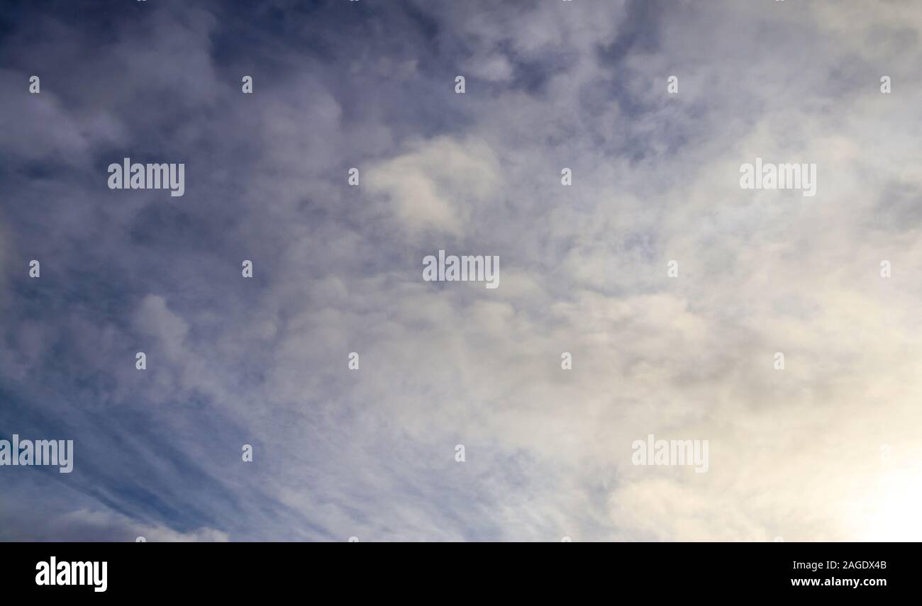 Detailed mixed clouds formations on a deep blue sky shot in northern ...
