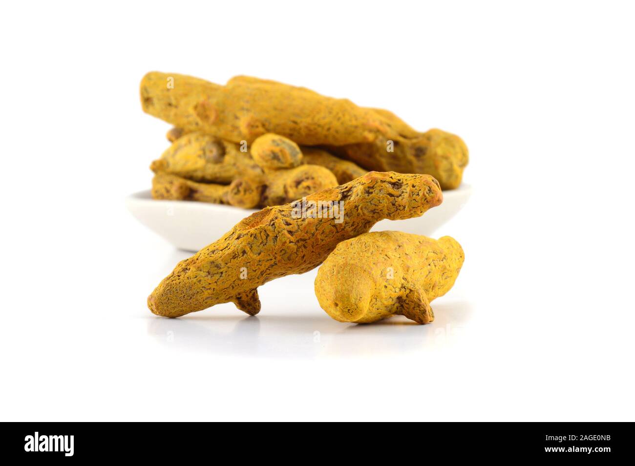 Dry Turmeric roots or barks in white plate isolated on white background ...