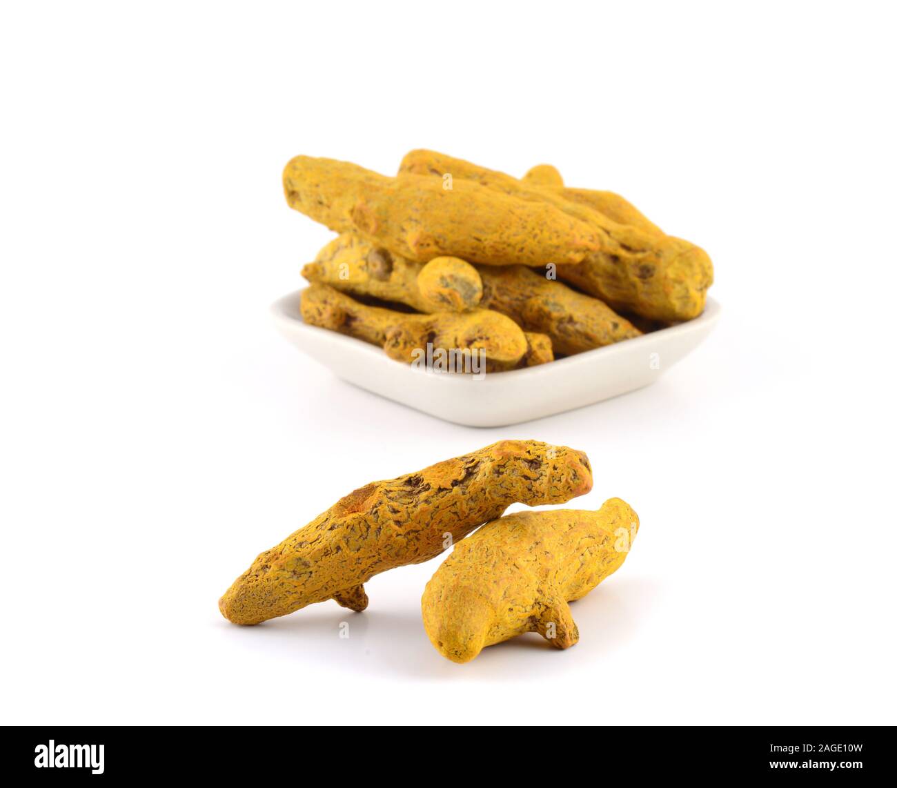 Dry Turmeric roots or barks in white plate isolated on white background ...