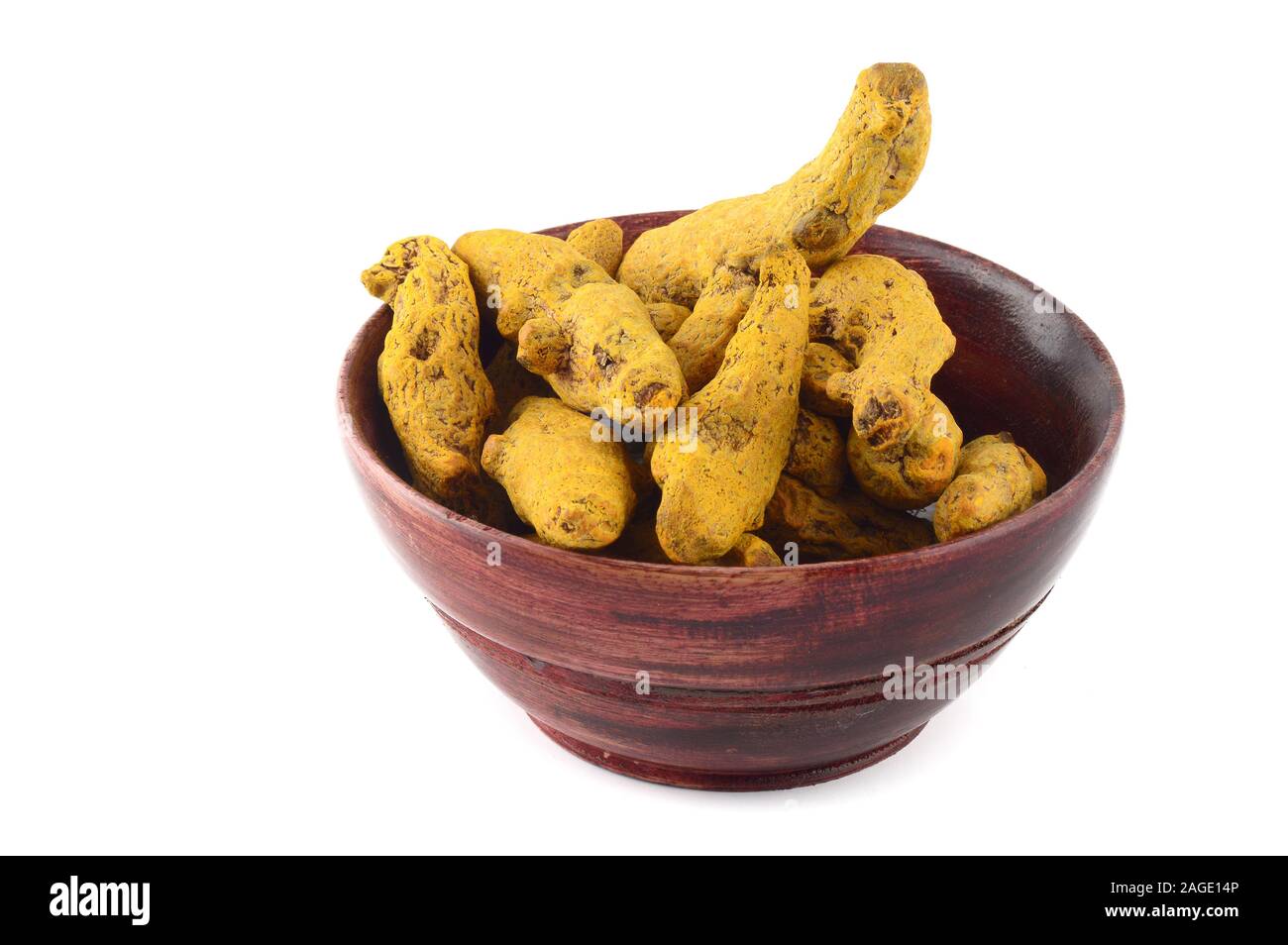 Dry Turmeric roots or barks in wooden bowl isolated on white background ...