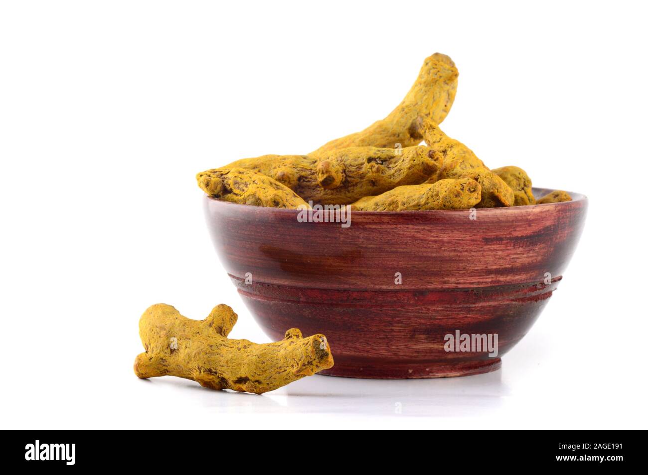 Dry Turmeric roots or barks in wooden bowl isolated on white background ...