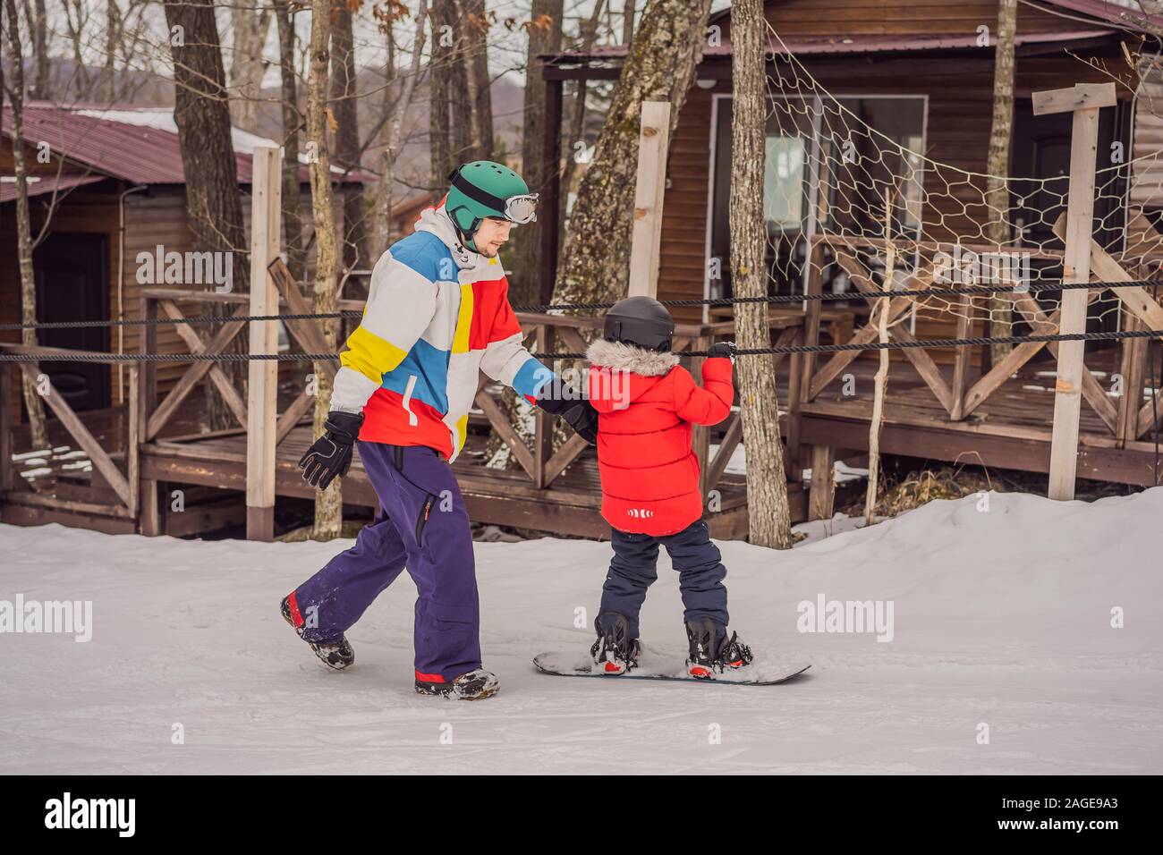 Snowboard instructor teaches a boy to snowboarding. Activities for ...