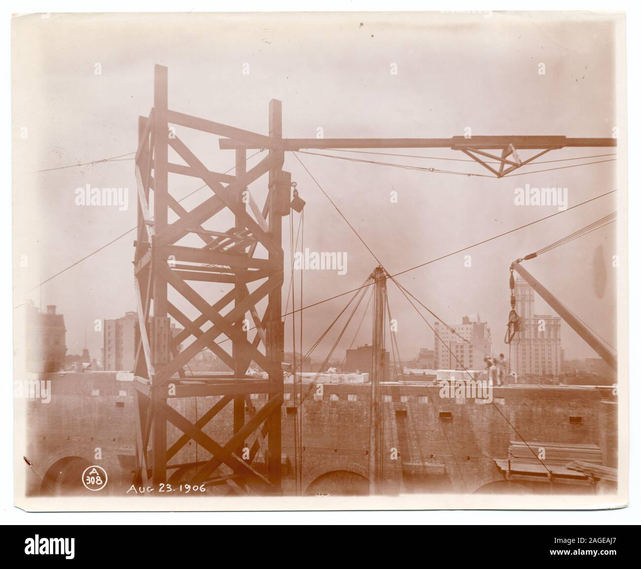 Interior work : hoisting machinery, and men pushing a marble block ...