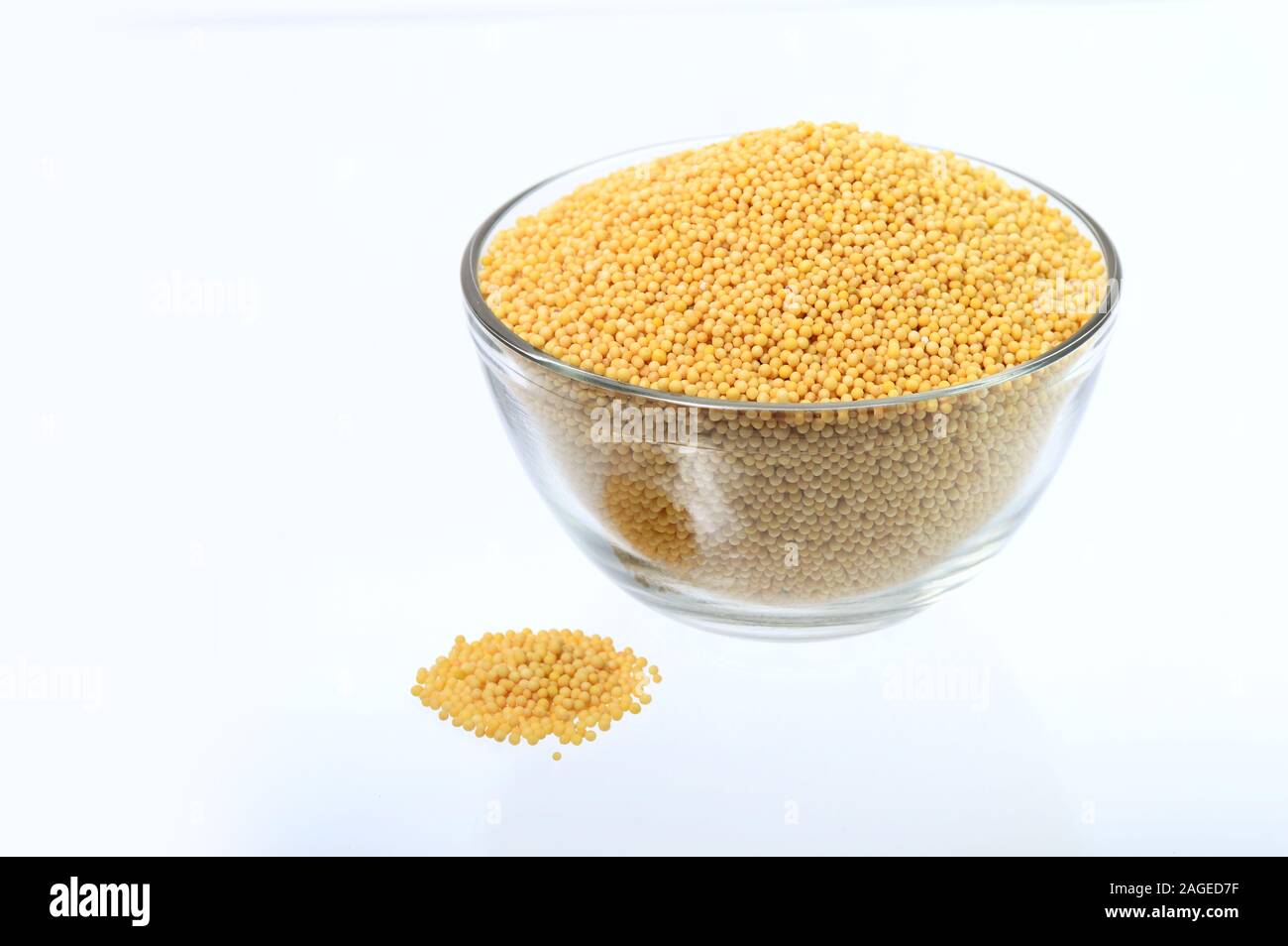 yellow mustard seeds in glass bowl isolated on white background Stock ...