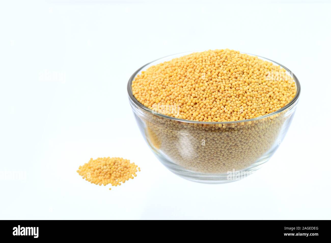 yellow mustard seeds in glass bowl isolated on white background Stock ...