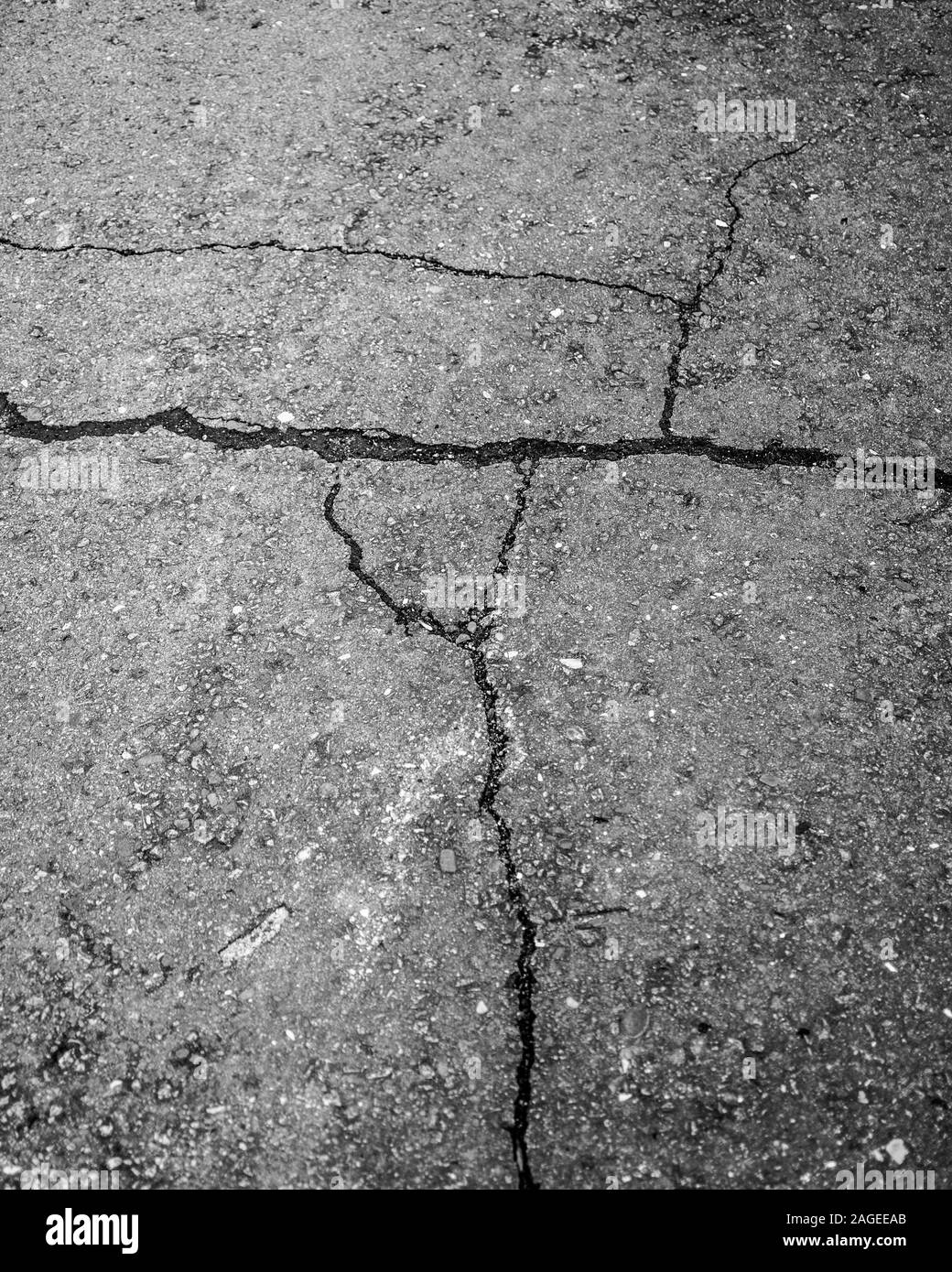 Cracked grey asphalt road - great for a background Stock Photo - Alamy
