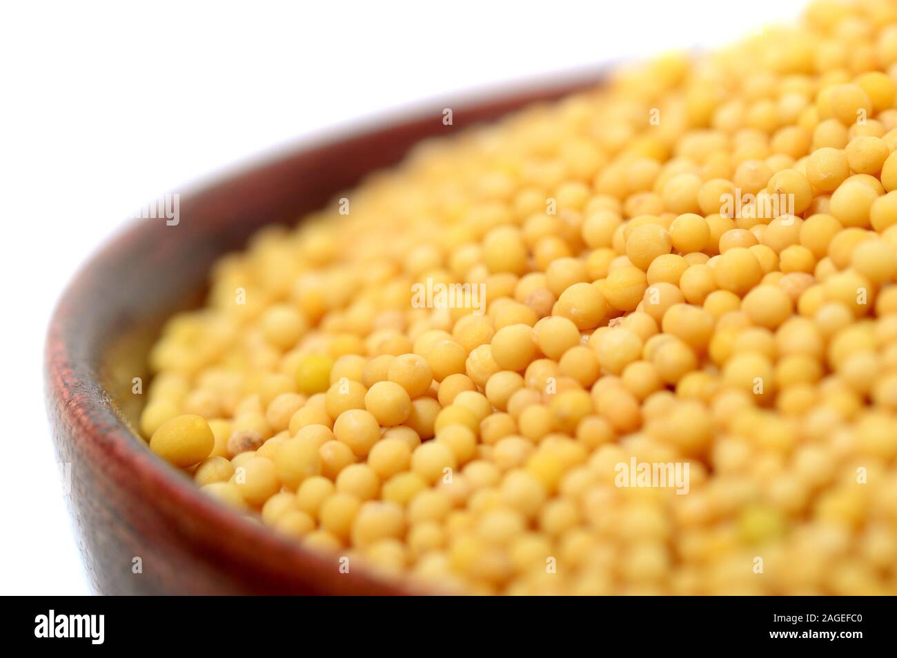 yellow mustard seeds in bowl isolated on white background Stock Photo ...