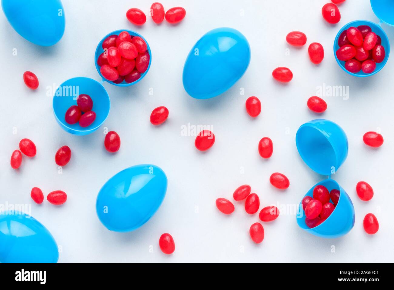 Red Jelly Beans Spilled from Blue Plastic Eggs Stock Photo - Alamy