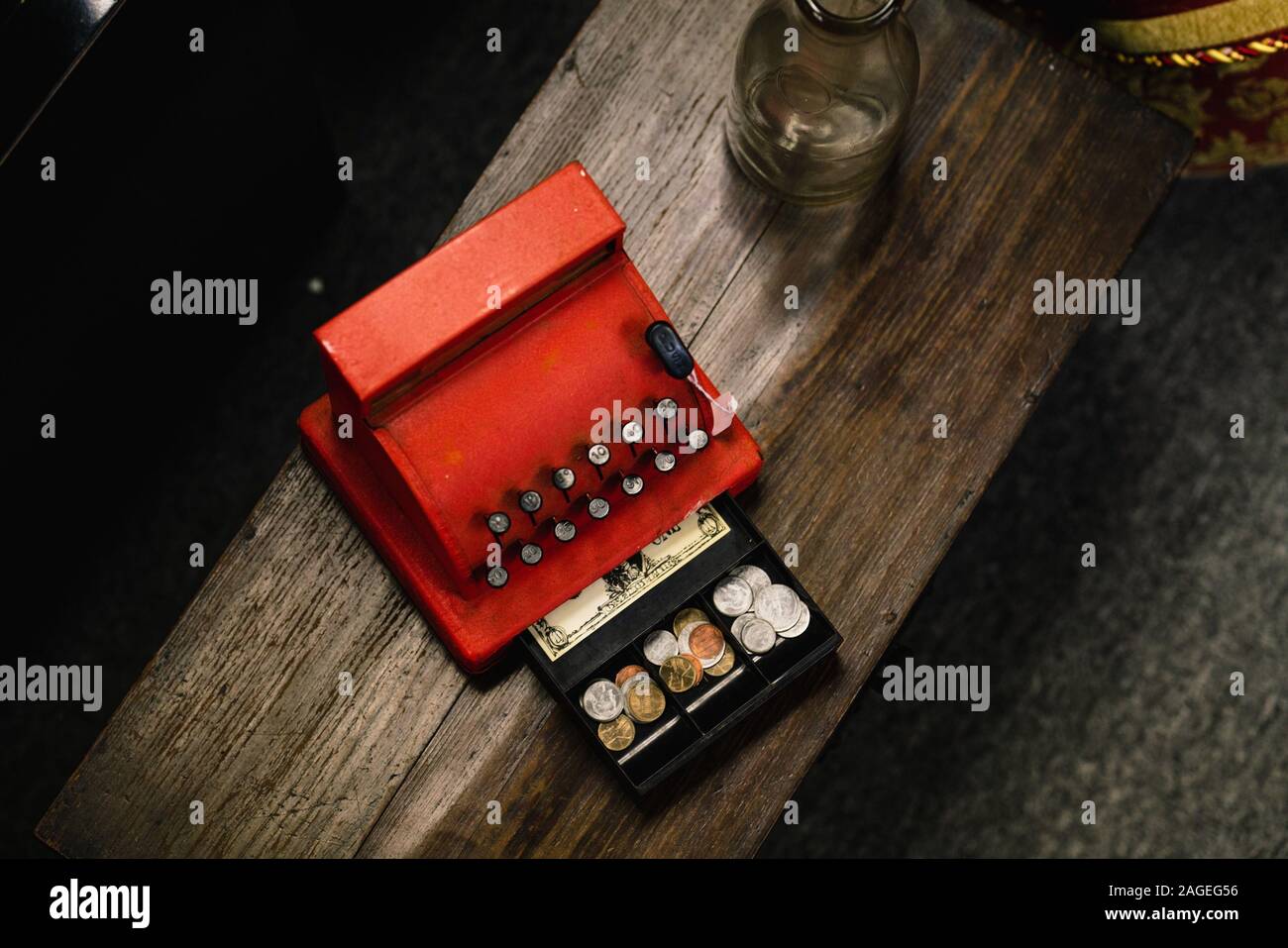 High angle shot of a small vintage cashier machine on a wooden surface ...