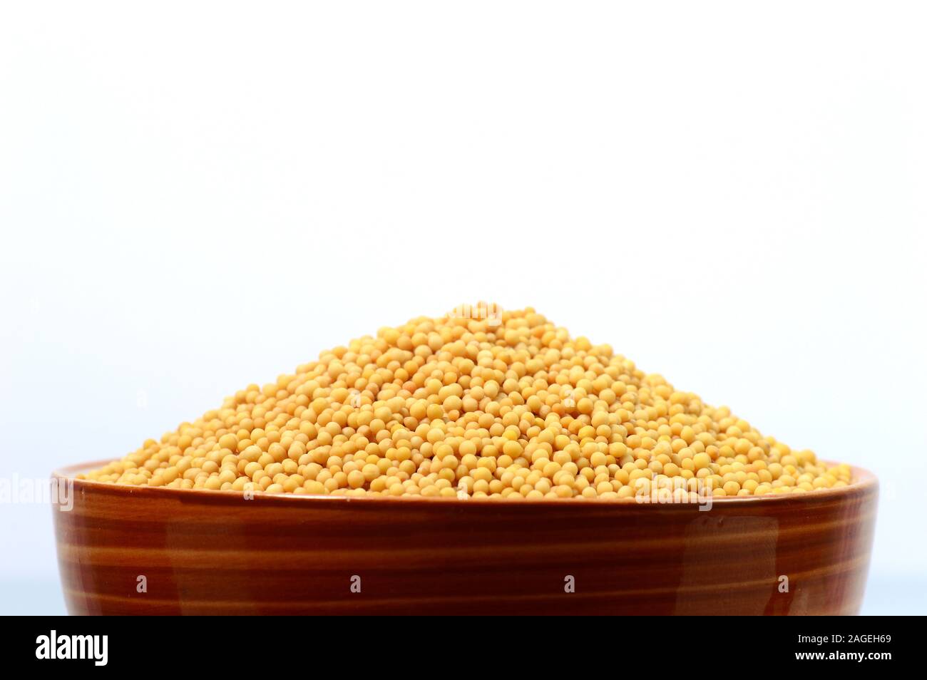 yellow mustard seeds in bowl isolated on white background Stock Photo ...