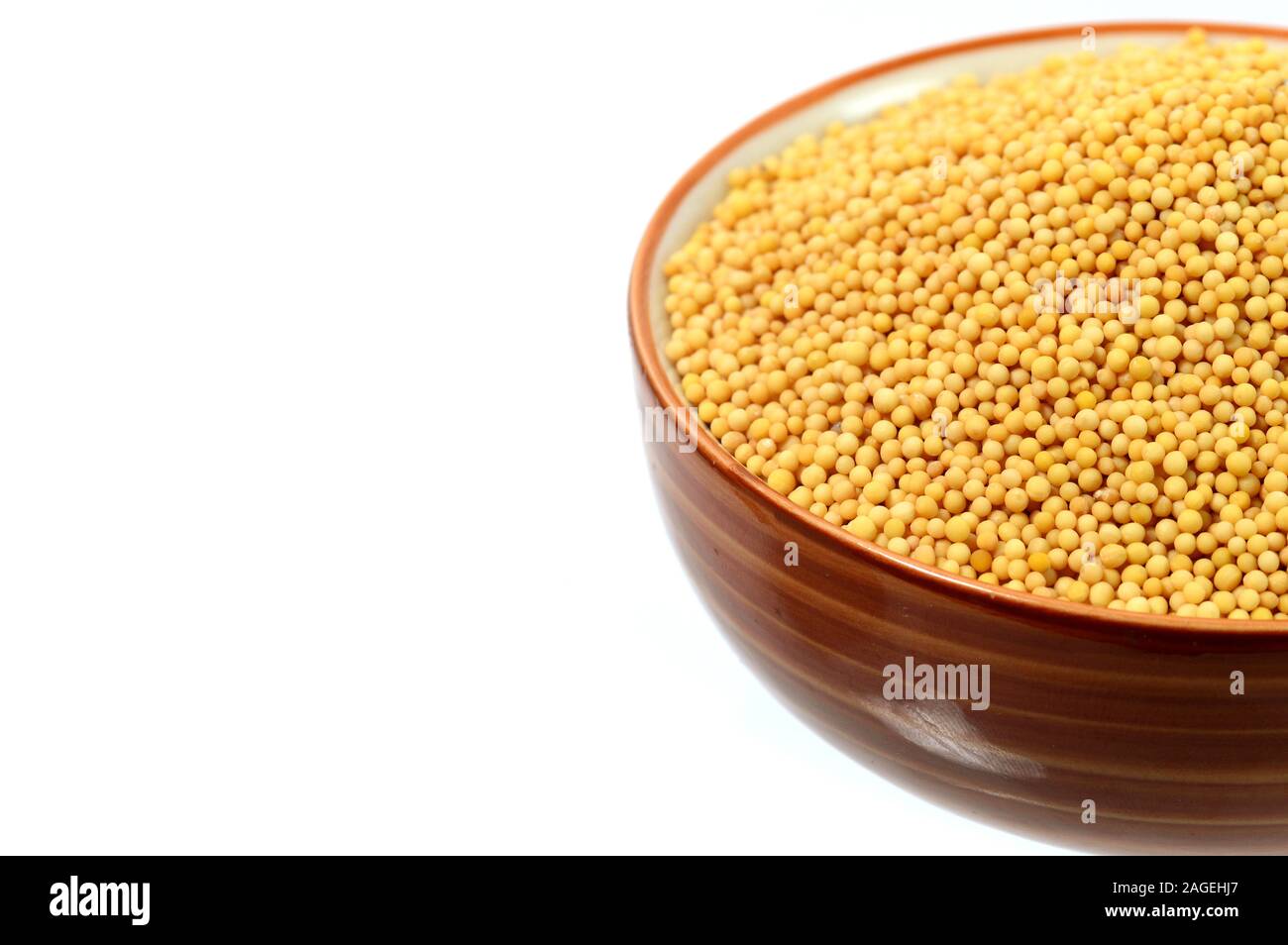 yellow mustard seeds in bowl isolated on white background Stock Photo ...
