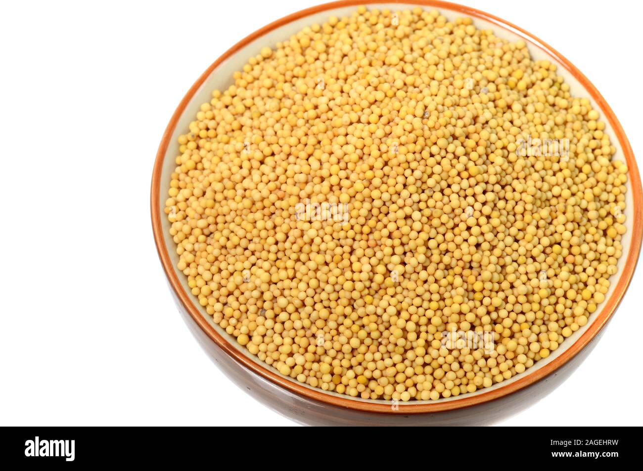 yellow mustard seeds in bowl isolated on white background Stock Photo ...