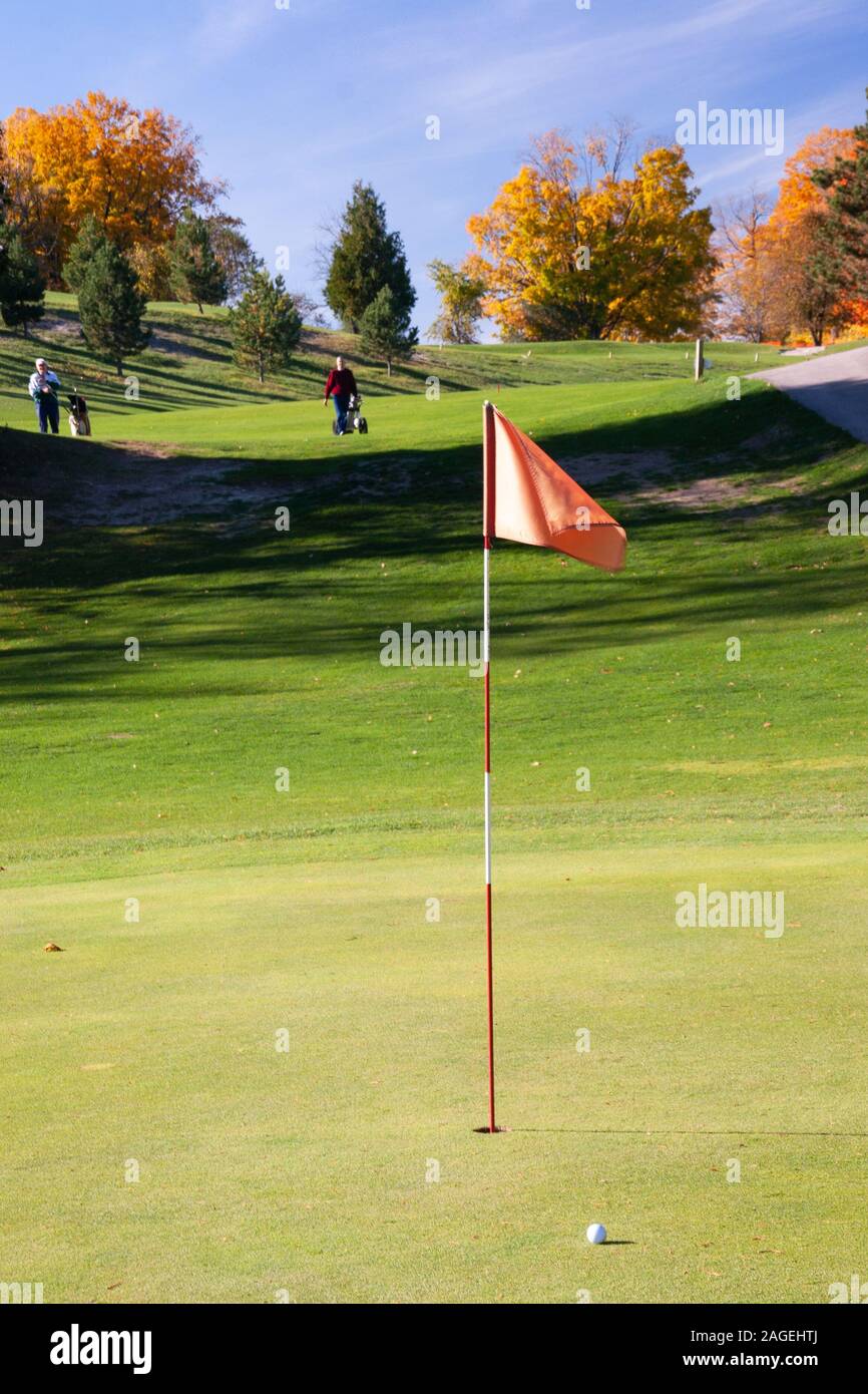 landscape fall foliage at Golf Course flag in hole at front Stock Photo ...
