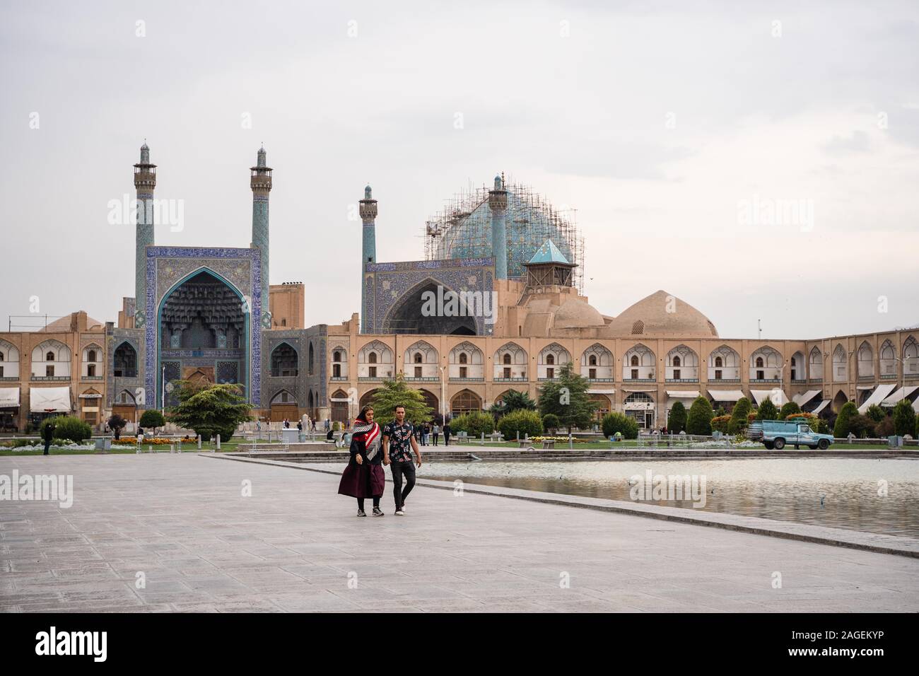 ESFAHAN, IRAN - Oct 22, 2019: Two Iranian people sitting on the royal ...