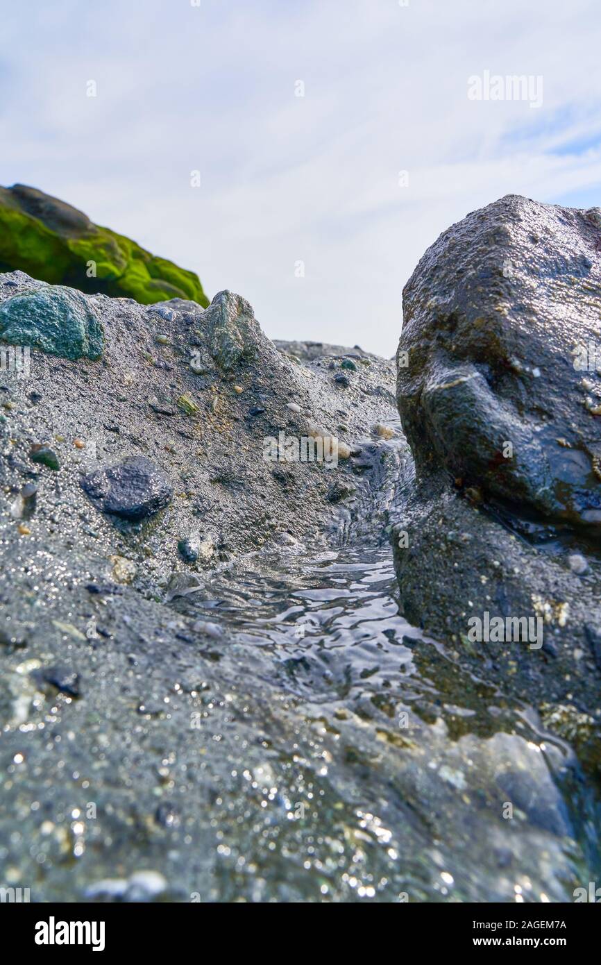 Vertical shot of a river flowing over rock formations Stock Photo - Alamy