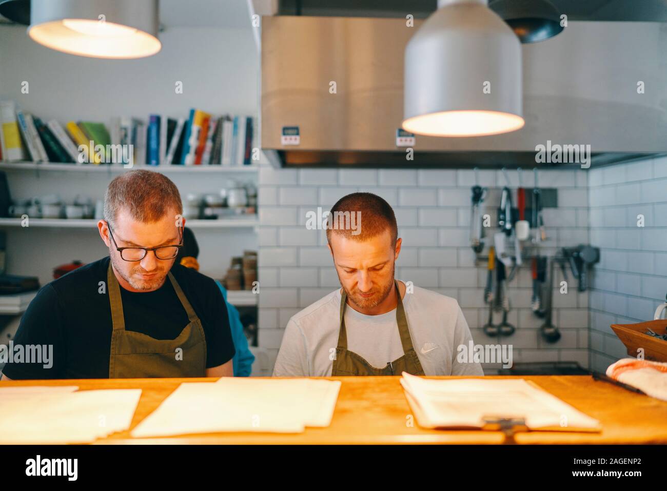 Waiters working behind service counter in restaurant Stock Photo - Alamy