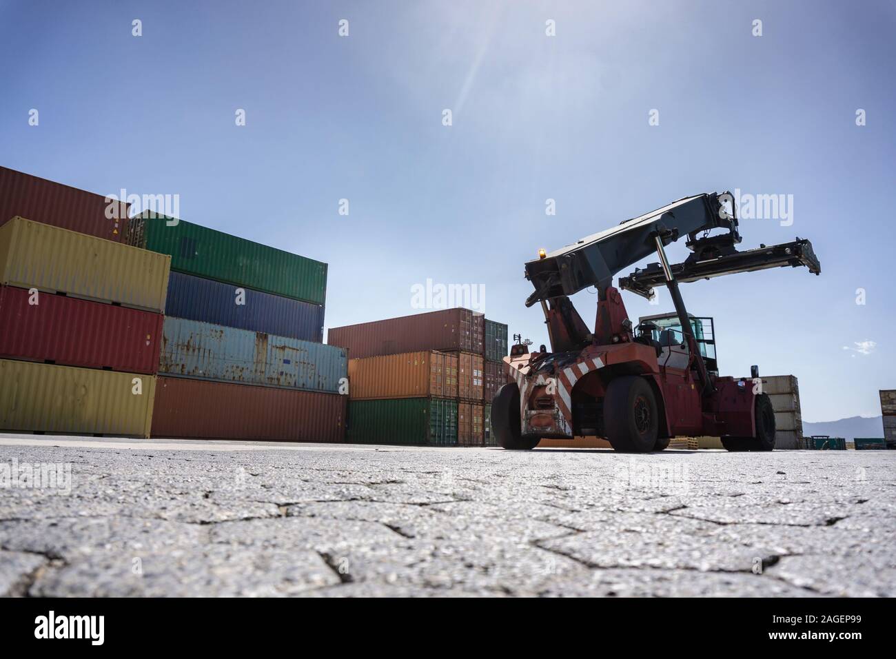 Reach stacker and shipping containers in dock Stock Photo - Alamy