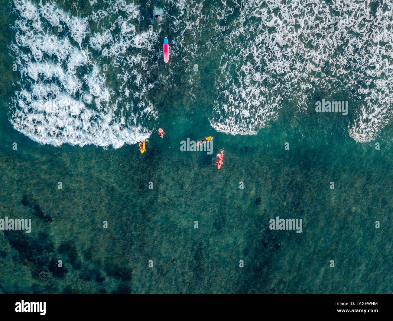 Aerial view of surfers in the ocean Stock Photo - Alamy